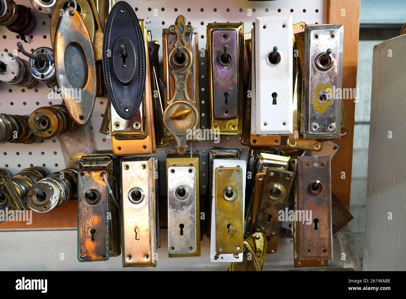 Collection of old used door knob plates Stock Photo - Alamy