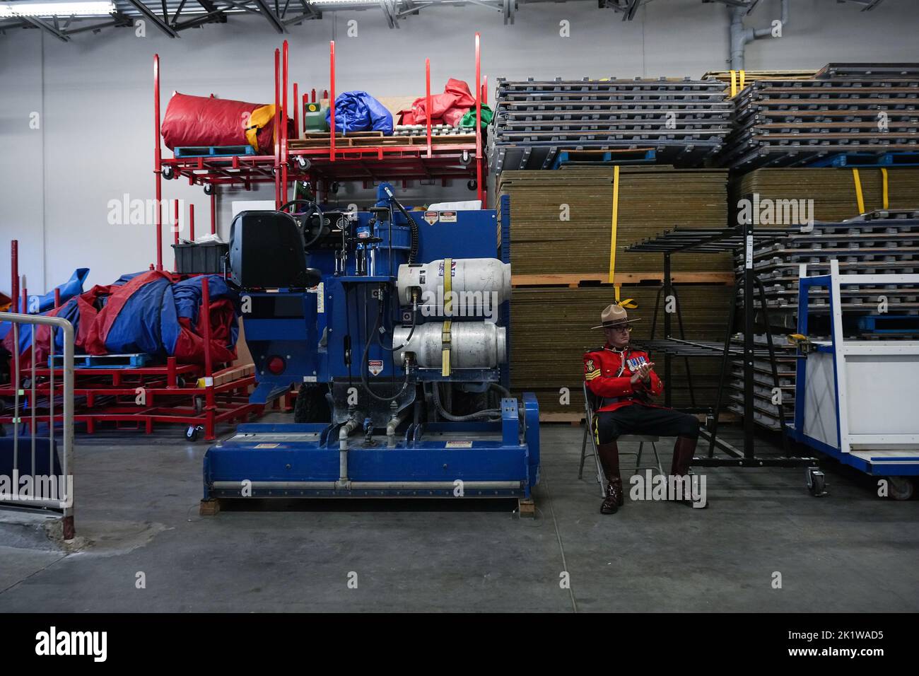 An RCMP officer sits next to a Zamboni while waiting for a change of ...