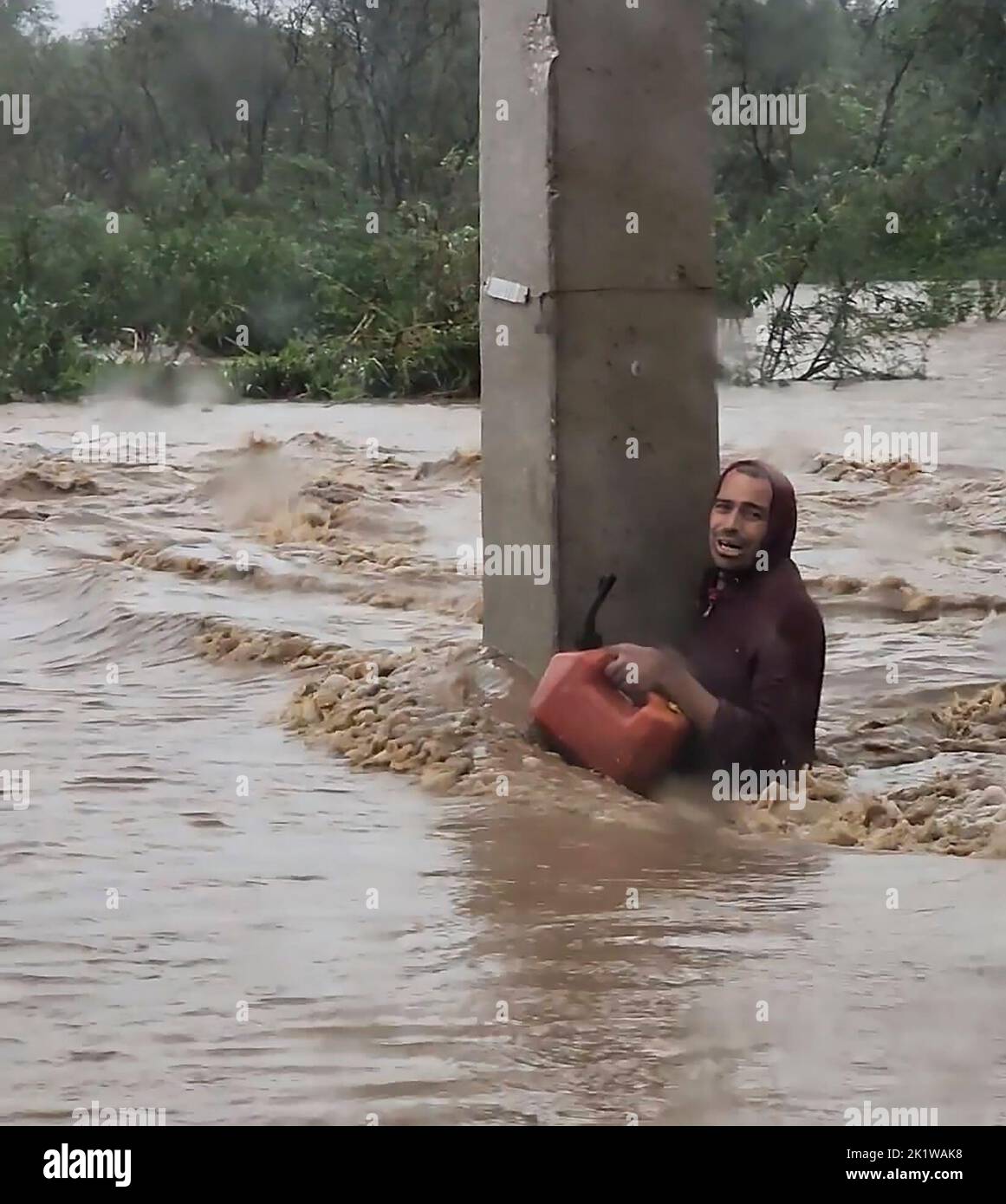 September 19, 2022, Ponce, Puerto Rico: A man clings to a concrete beam ...