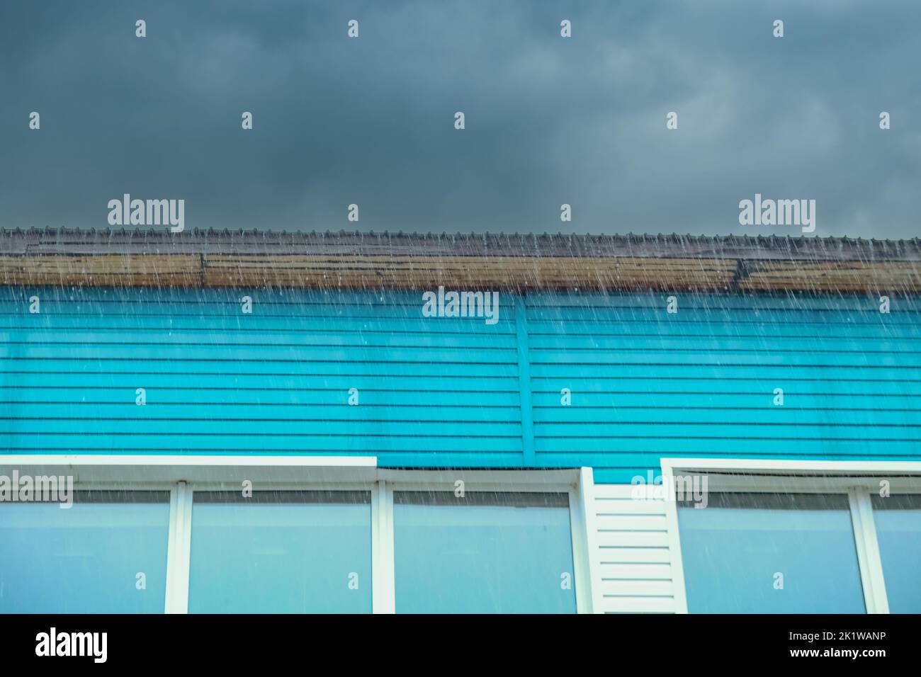 Heavy rain on the background of gray clouds. Heavy rain pours from the ...