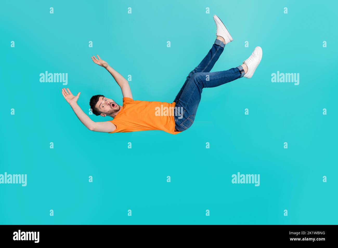 Full size photo of frightened guy falling downward by accident isolated ...
