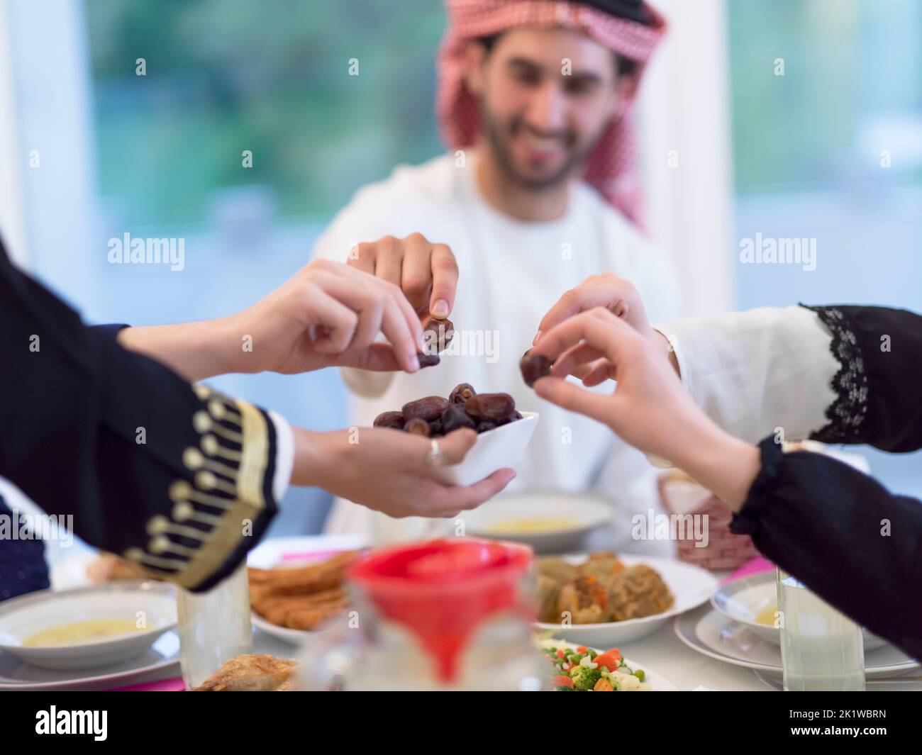 modern multiethnic muslim family sharing a bowl of dates while enjoying ...