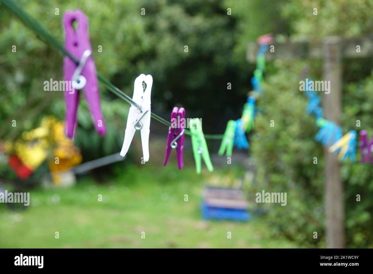 Pegs on clothesline Stock Photo - Alamy
