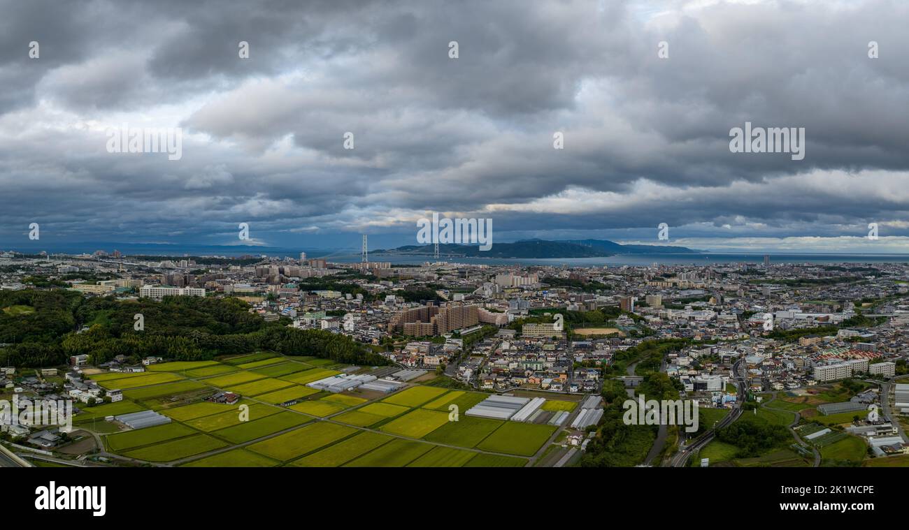 Dramatic typhoon clouds over rice fields at edge of town Stock Photo ...