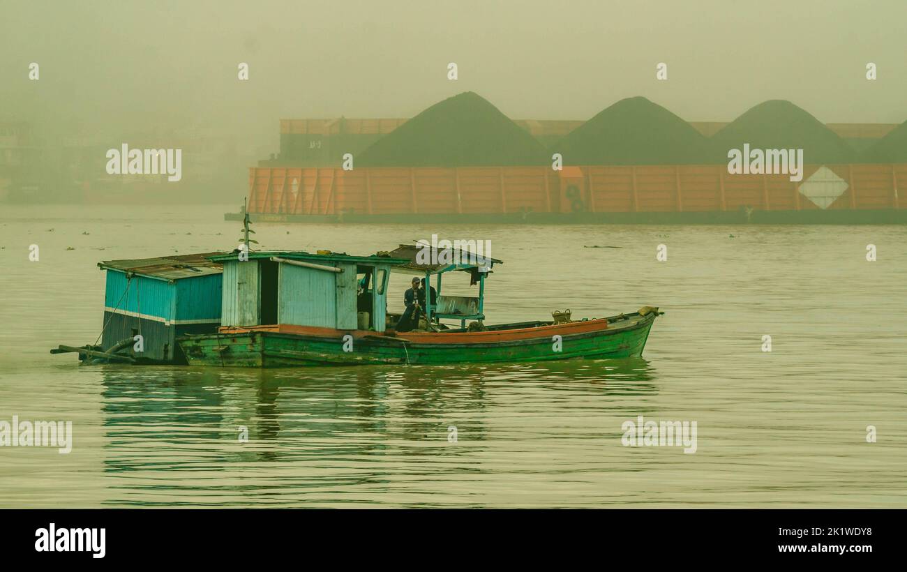 Sand miner activity at Mahakam River, Samarinda in the morning. Wooden ...