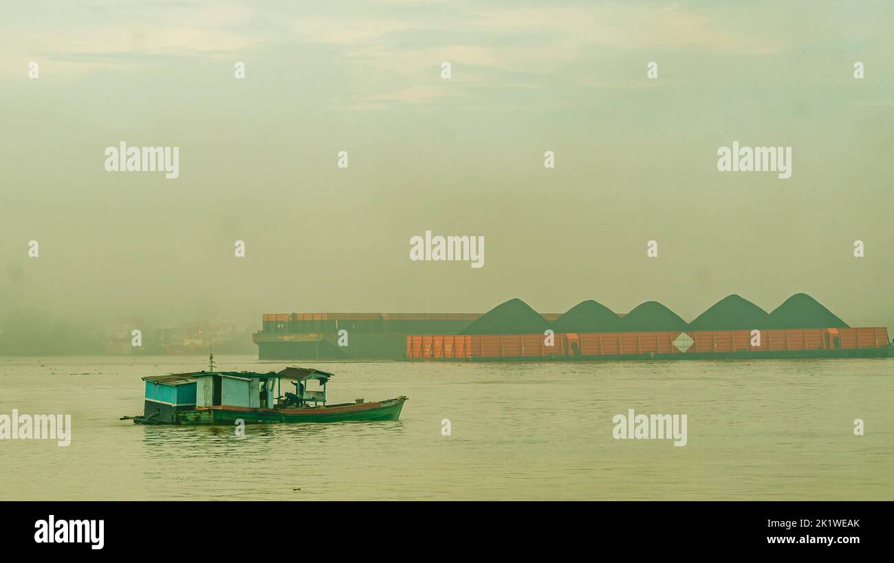 Sand miner activity at Mahakam River, Samarinda in the morning. Wooden ...