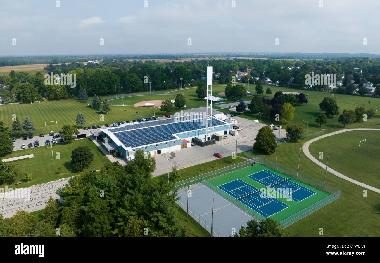 An aerial view looking at a rural sports building and facility with ...