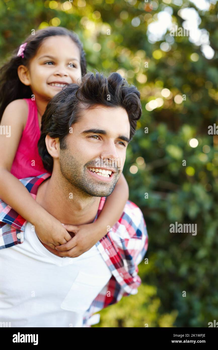 Hes an exceptional father. A handsome young father piggybacking his ...