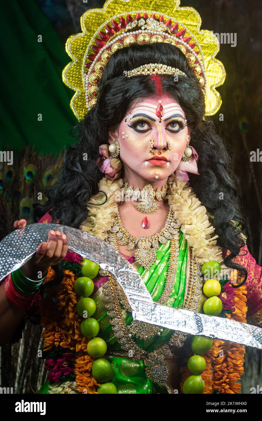 Concept Agomoni shoot with black haired Indian brunette woman face with ...