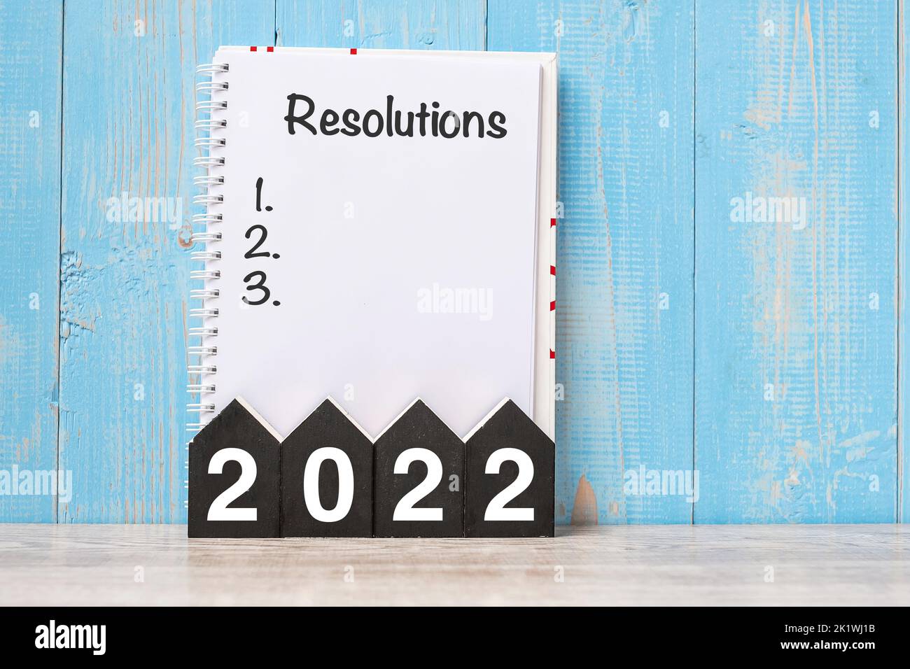 2022 Happy New Year with RESOLUTIONS word and wooden number. time for a ...
