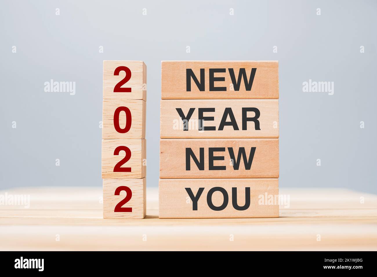 Businessman hand holding wooden block with text 2022 NEW YEAR NEW YOU ...