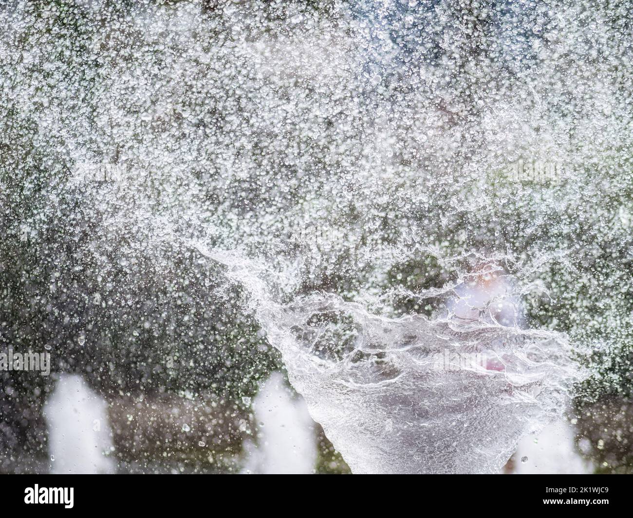 Water splashes from fountain on dark background. Natural texture of ...