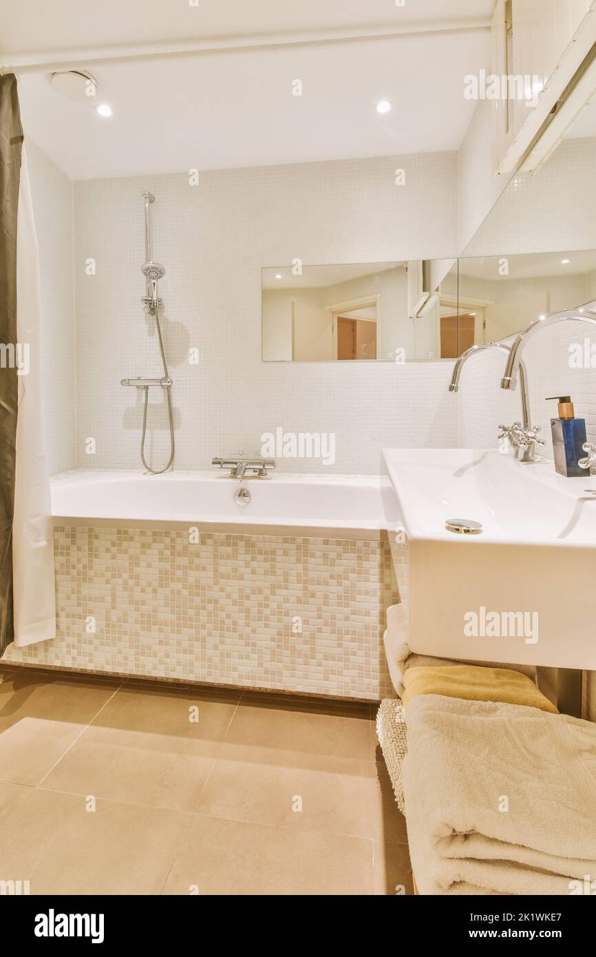 Sinks with mirrors and clean bathtub in modern bathroom with white ... Sinks with mirrors and clean bathtub in modern bathroom with white ...