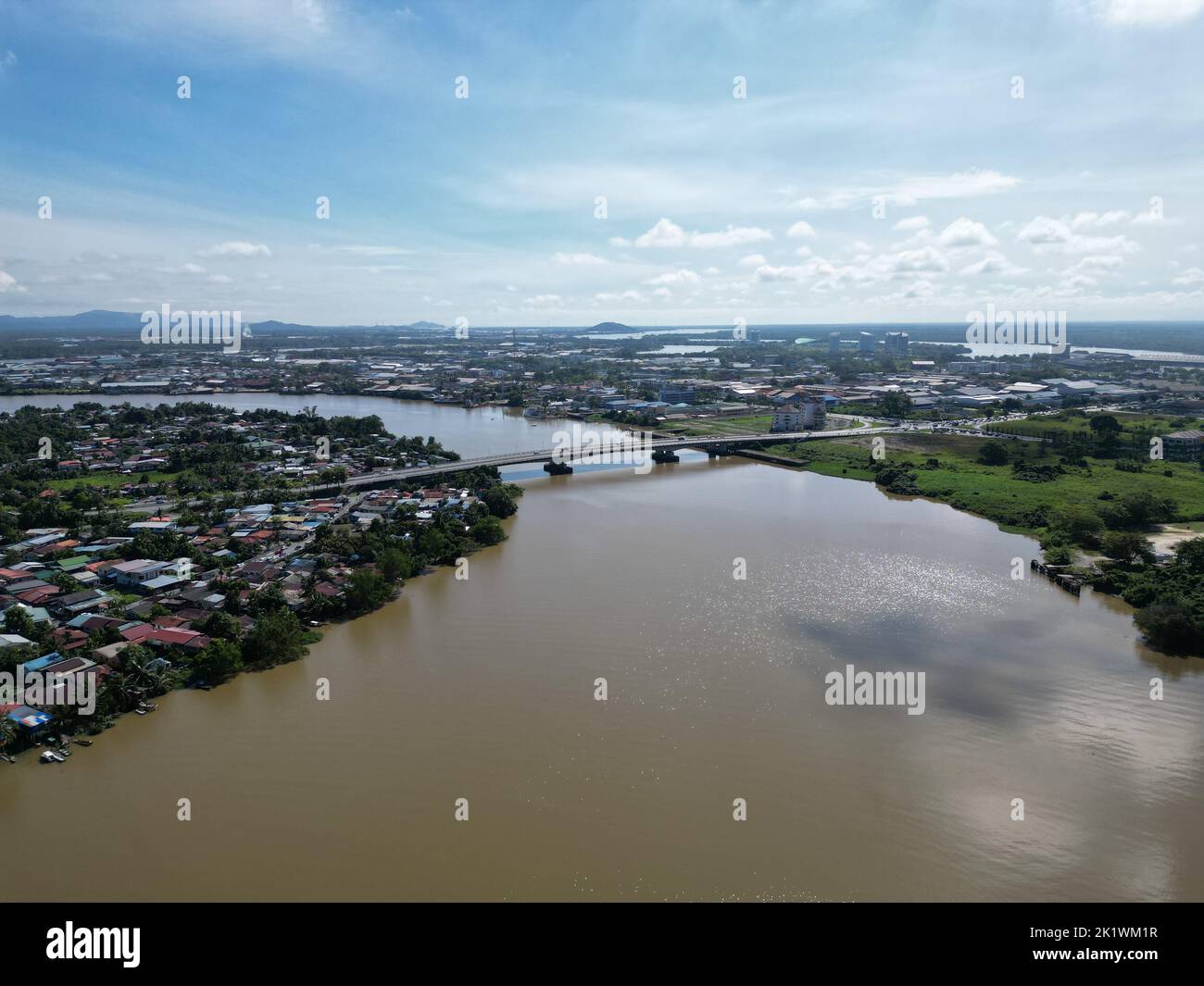 A bridge over the Sarawak River in Kuching City with houses under the ...