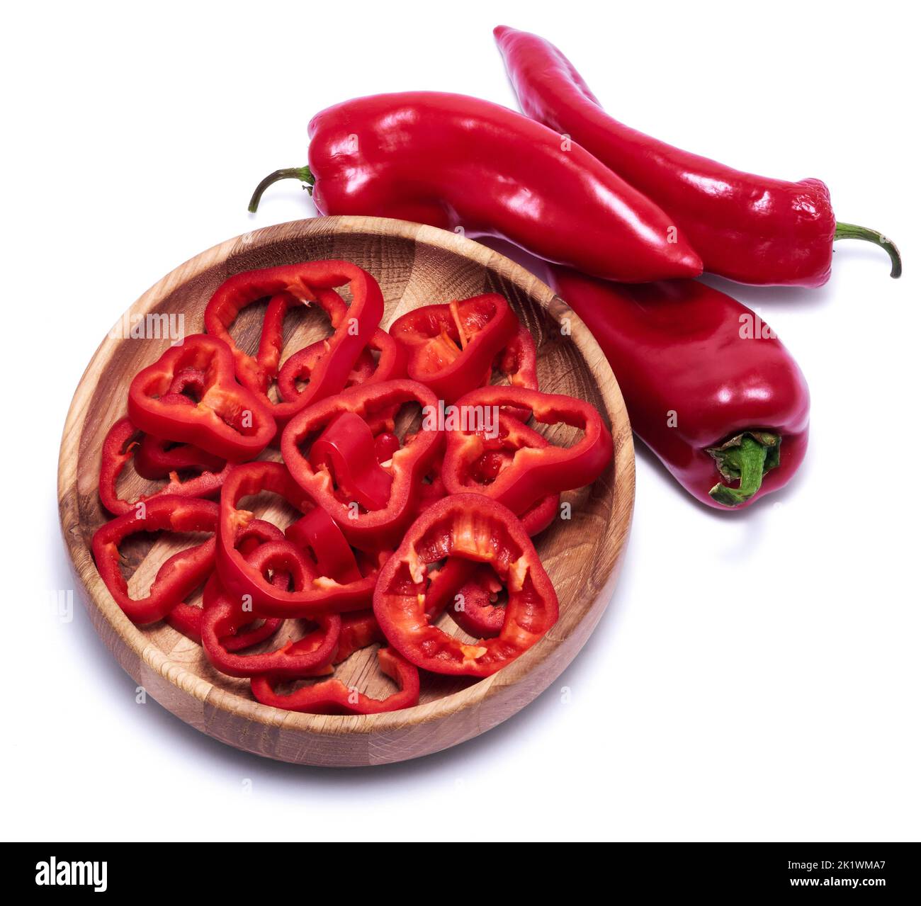 sliced red pepper in wooden bowl isolated on white background Stock ...