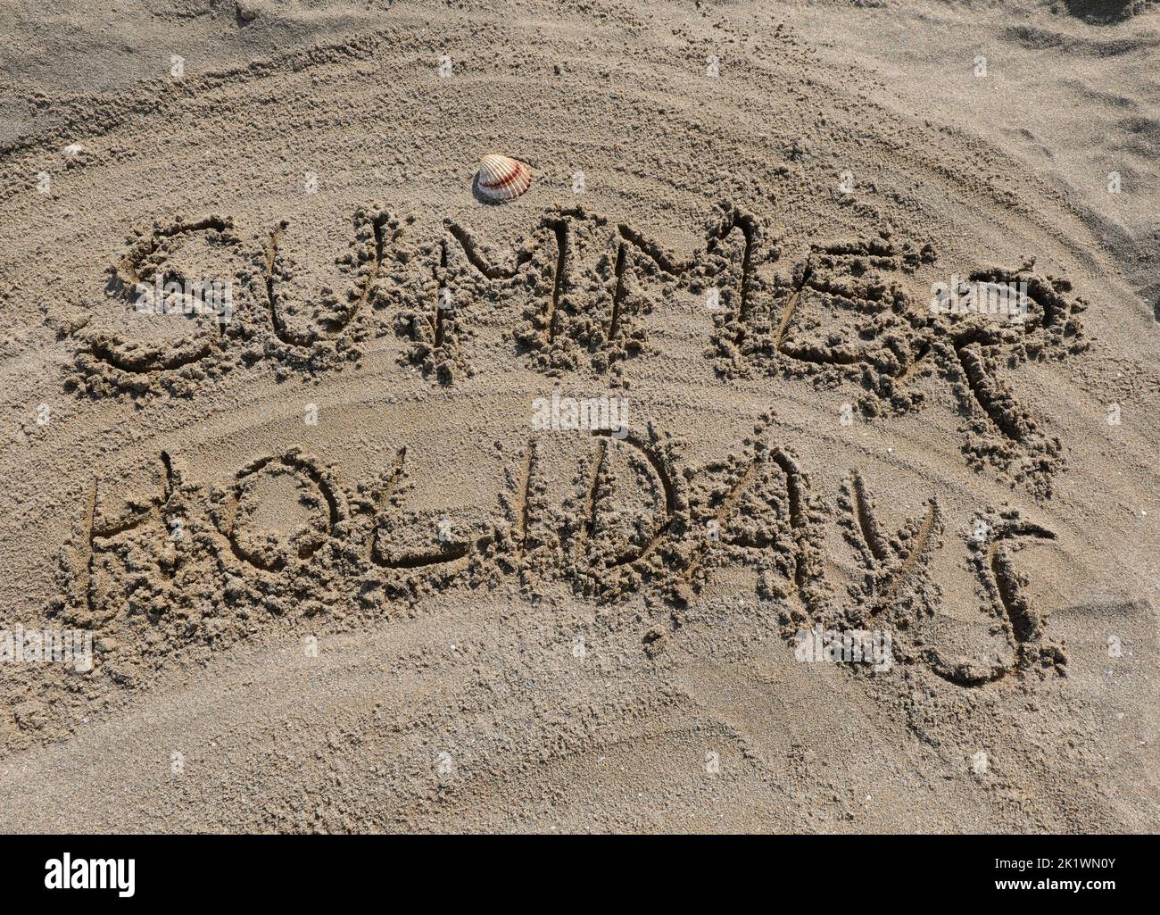 Words SUMMER HOLIDAYS writte on the sand of beach Stock Photo - Alamy