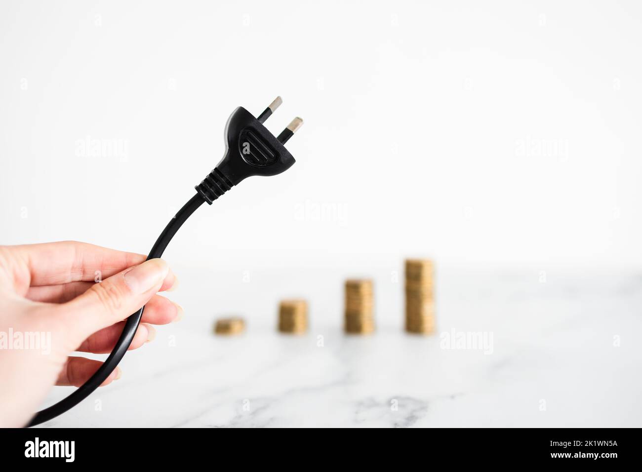 electricity costs going up conceptual image, plug with growing stacks ...
