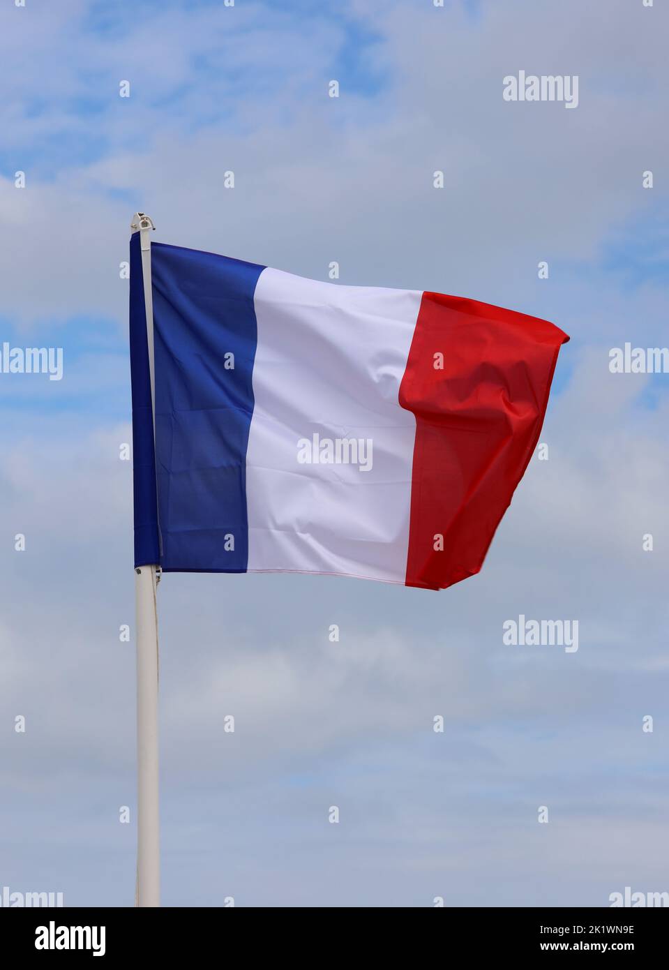 big French flag waving blue sky background Stock Photo - Alamy