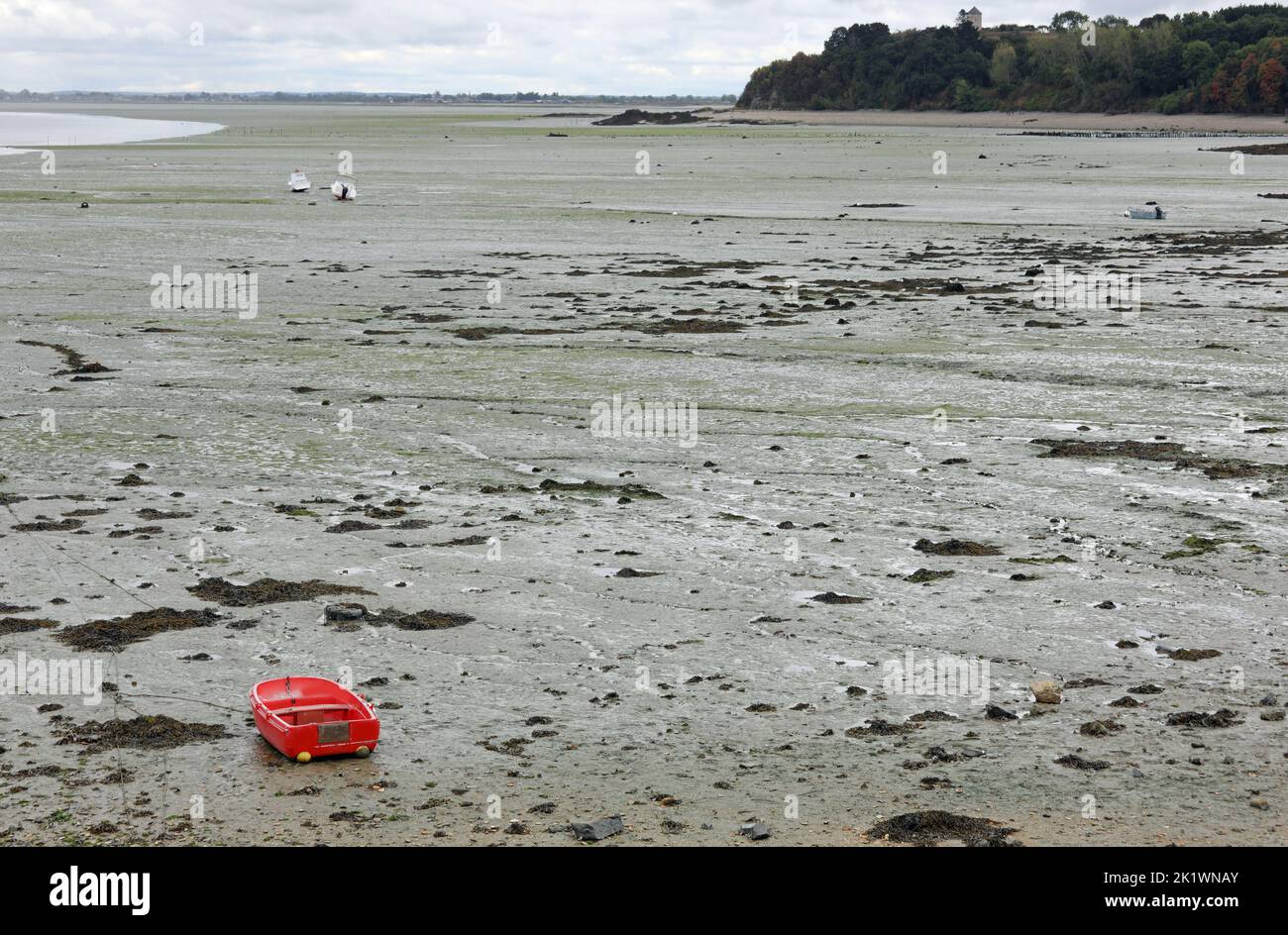 beached red Boat on the muddy sand at low tide in Europe Stock Photo ...