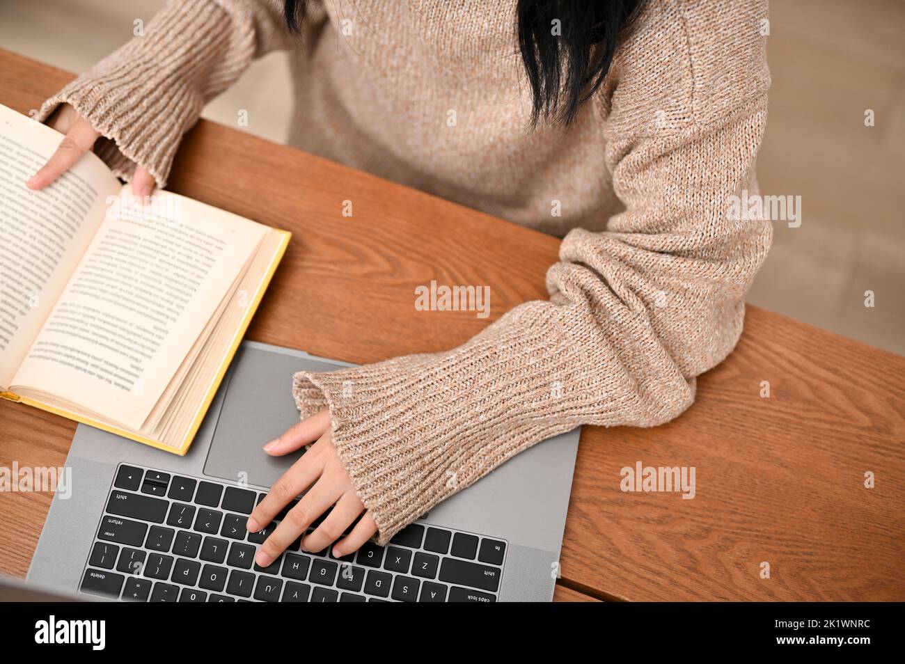 Above view, An Asian female college student doing her homework, working ...