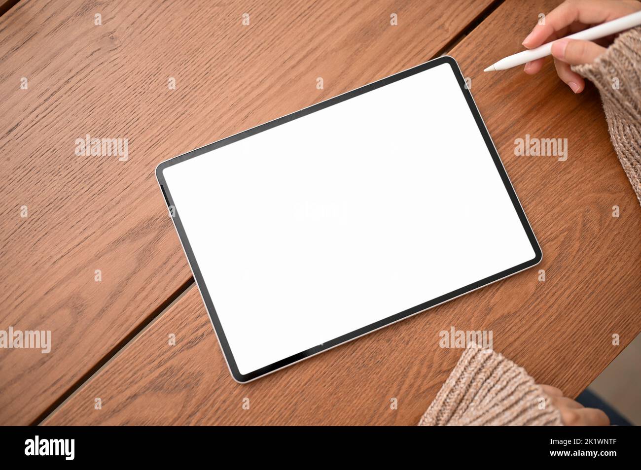 Top view, A female using stylus pen drawing on digital tablet touchpad ...