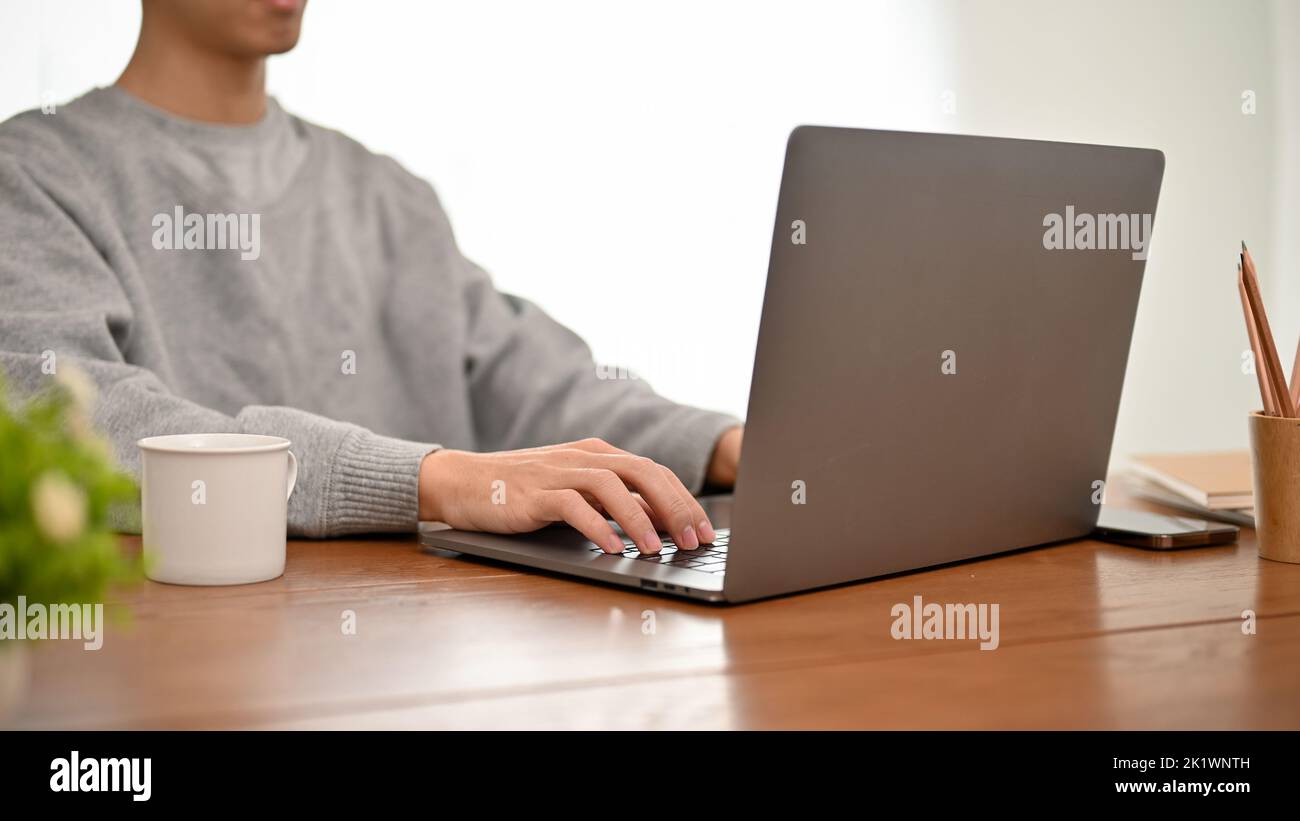 Professional Asian male programmer working at his office desk, using ...