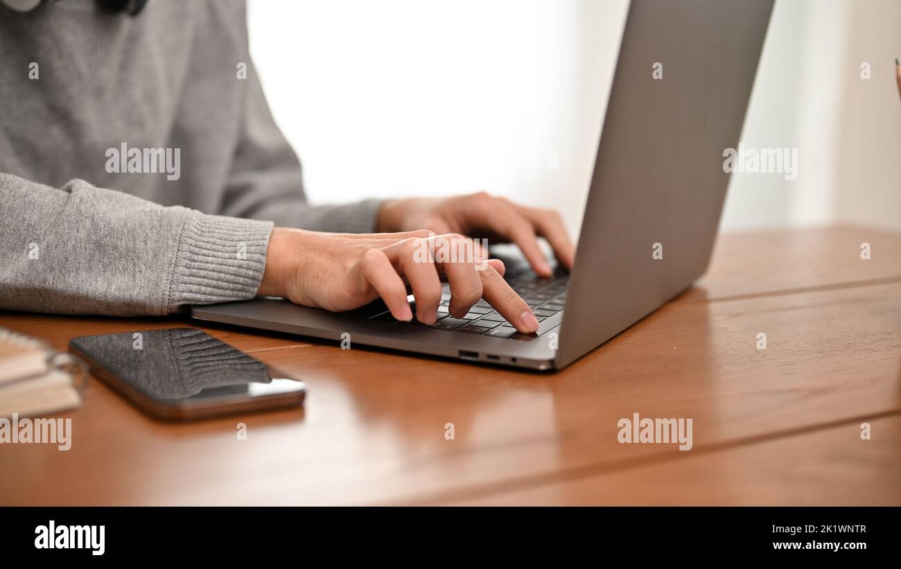 A businessman remote working at the coffee shop, using laptop computer ...
