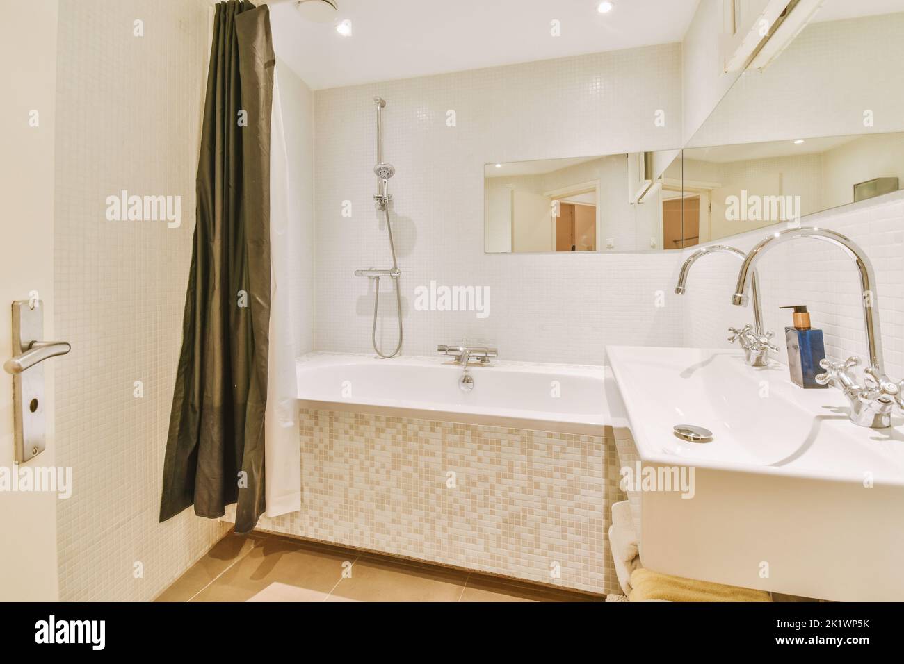 Sinks with mirrors and clean bathtub in modern bathroom with white ...