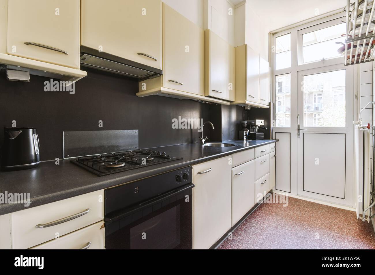 Fragment of interior of light narrow home kitchen with minimalist style ...