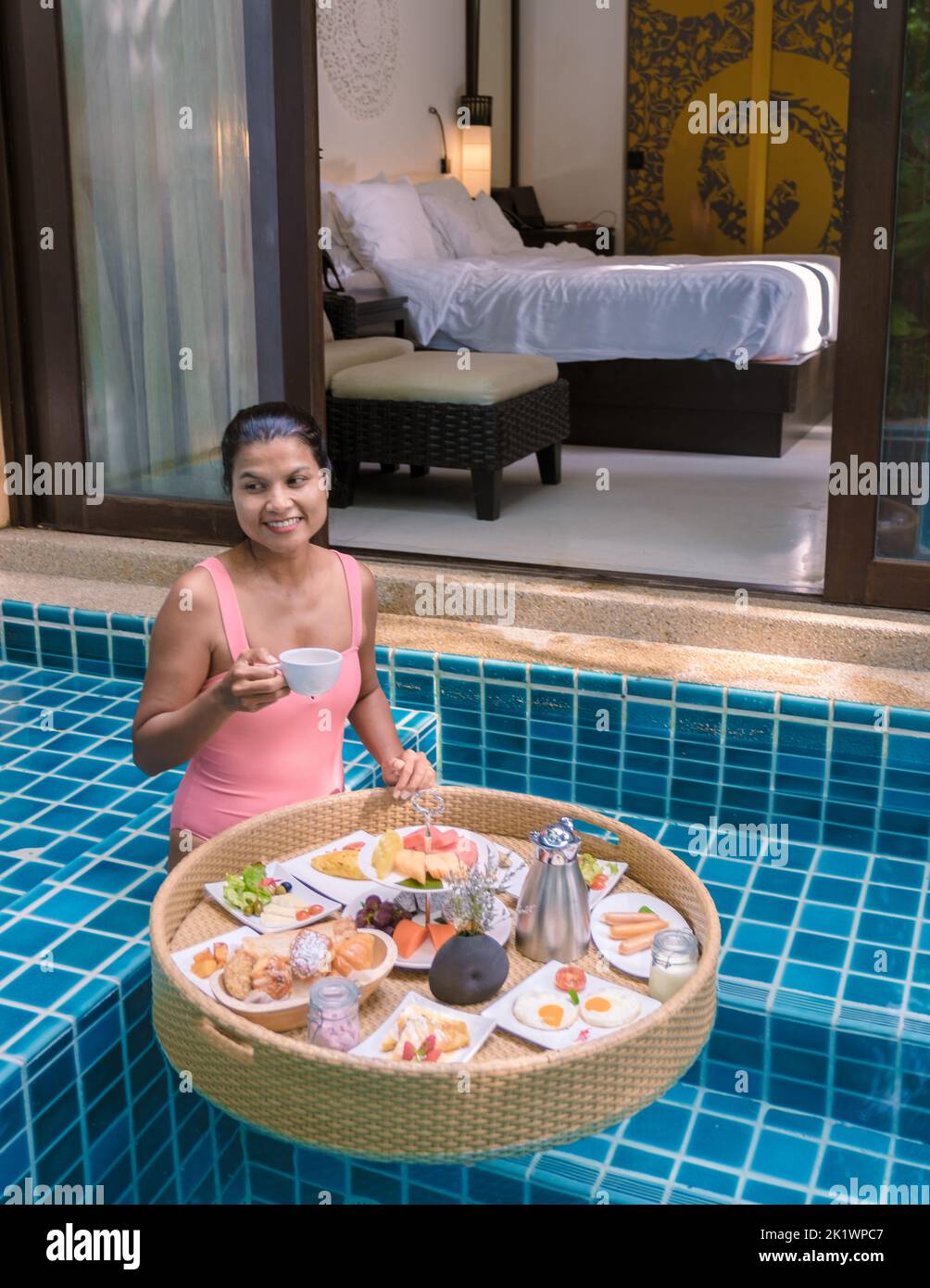 A women having breakfast in the swimming pool, Asian women having ...