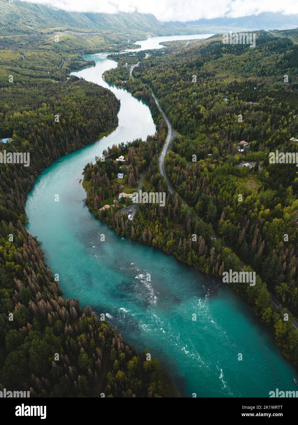 A vertical aerial view of the Kenai River flowing in a forest ...