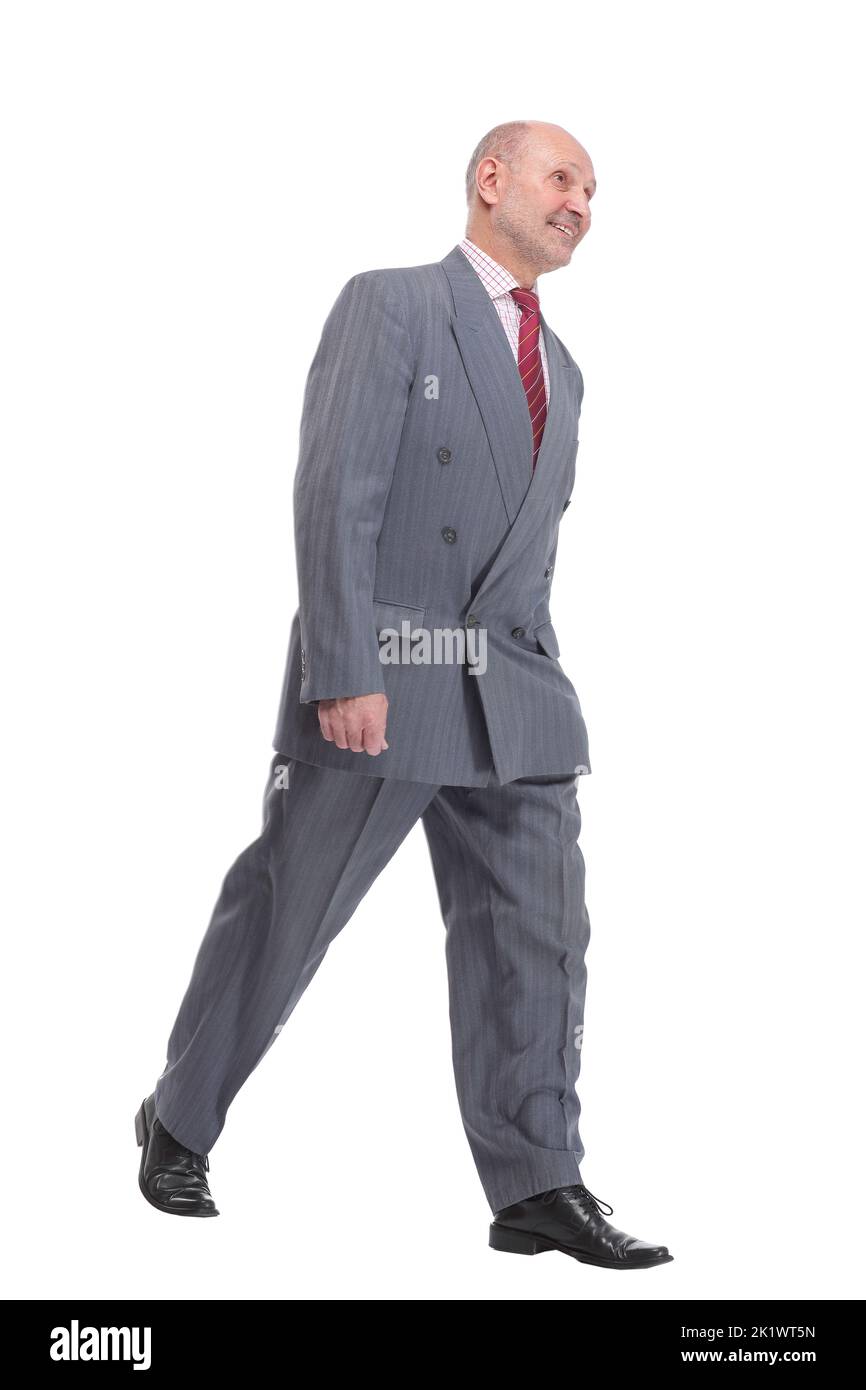 full length picture of a senior business man walking towards the camera ...