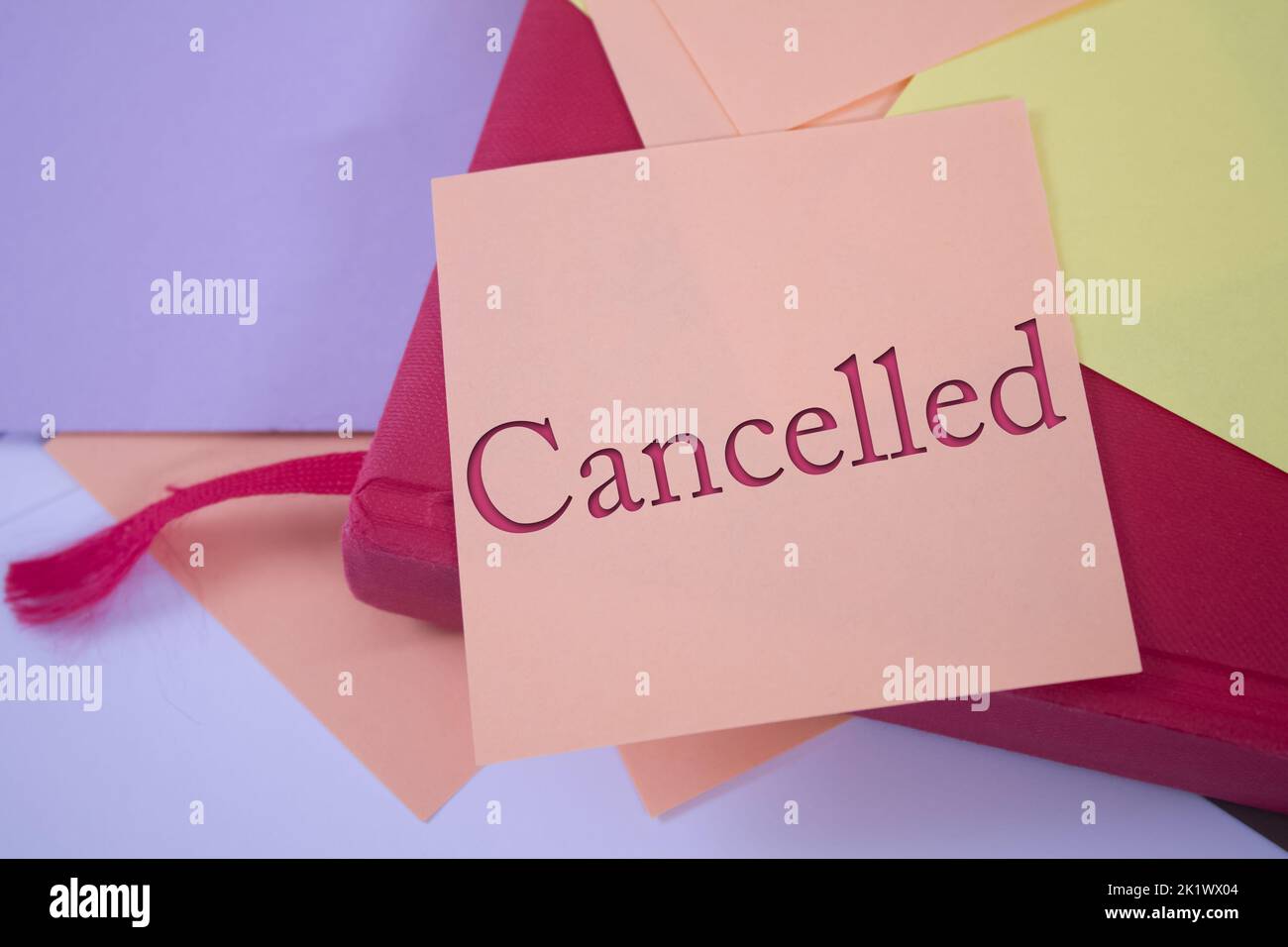 Cancelled. Text on adhesive note paper. Event, celebration reminder ...