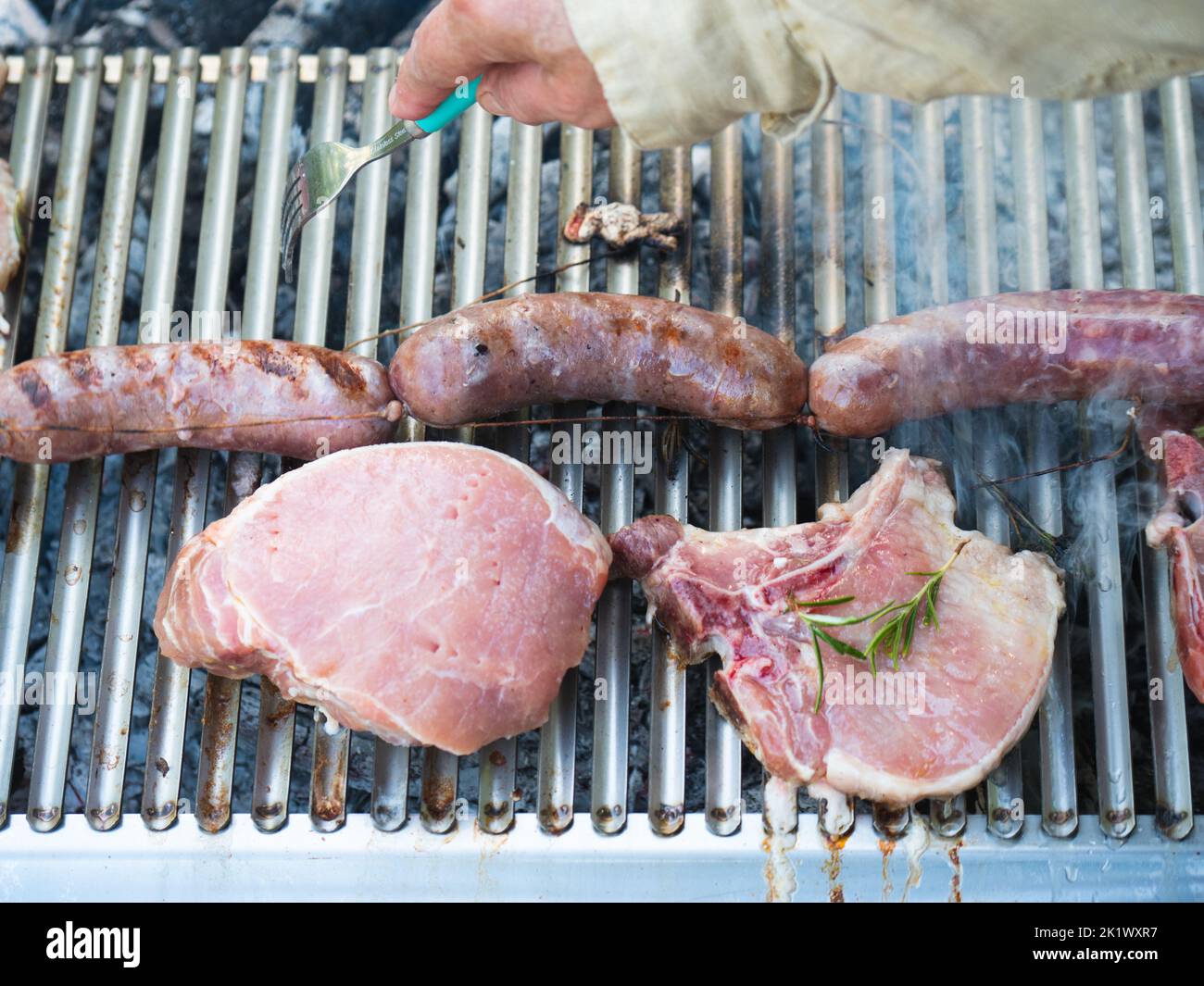 cooking pork meat in the grill outdoors with charcoal Stock Photo - Alamy