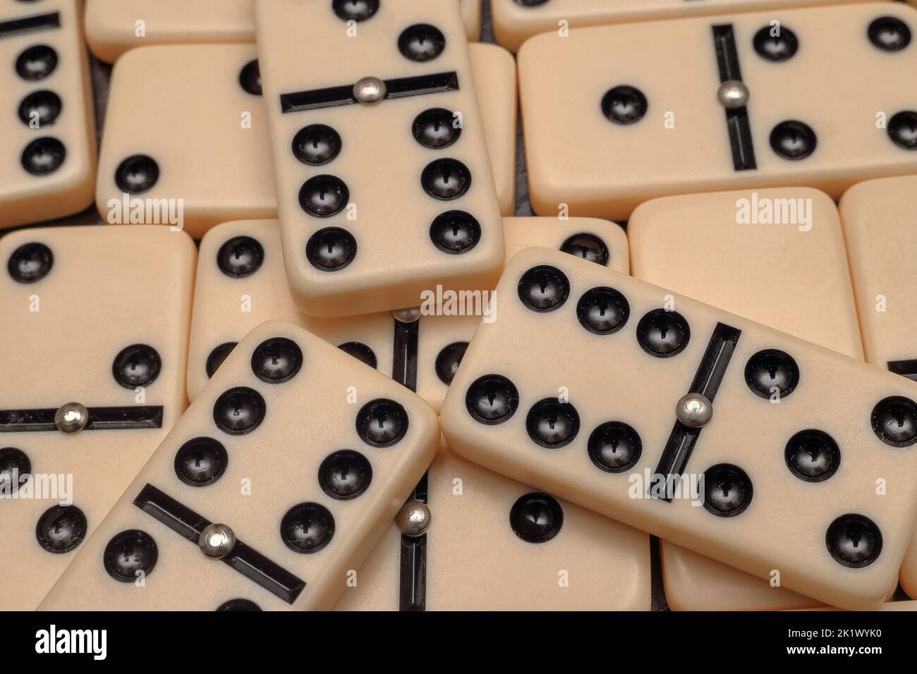 Scattered yellow dominoes lying on top of each other Stock Photo - Alamy