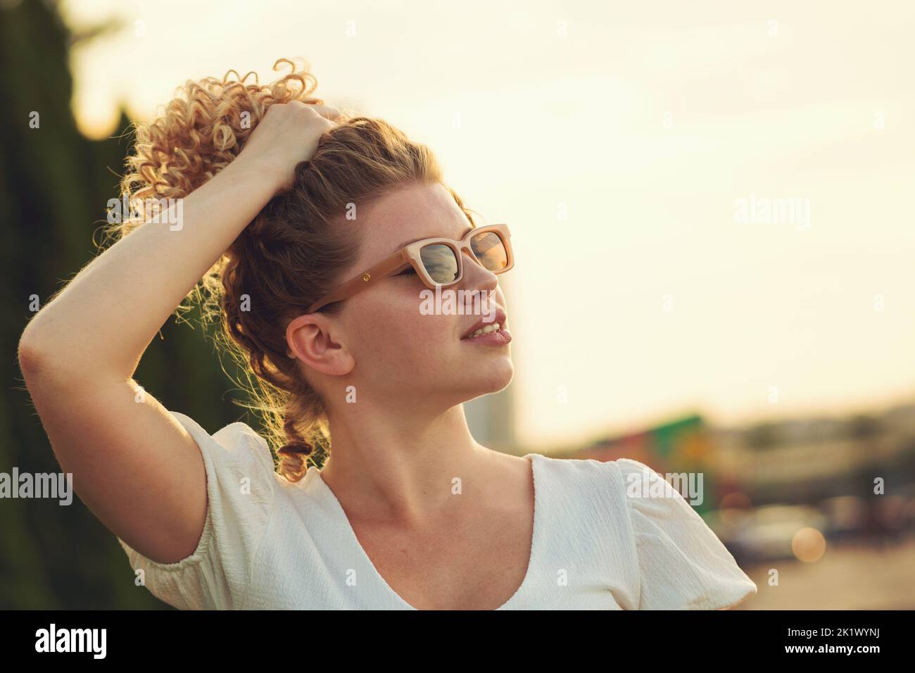 Thoughtful dreamy caucasian woman with afro curls hairstyle posing ...