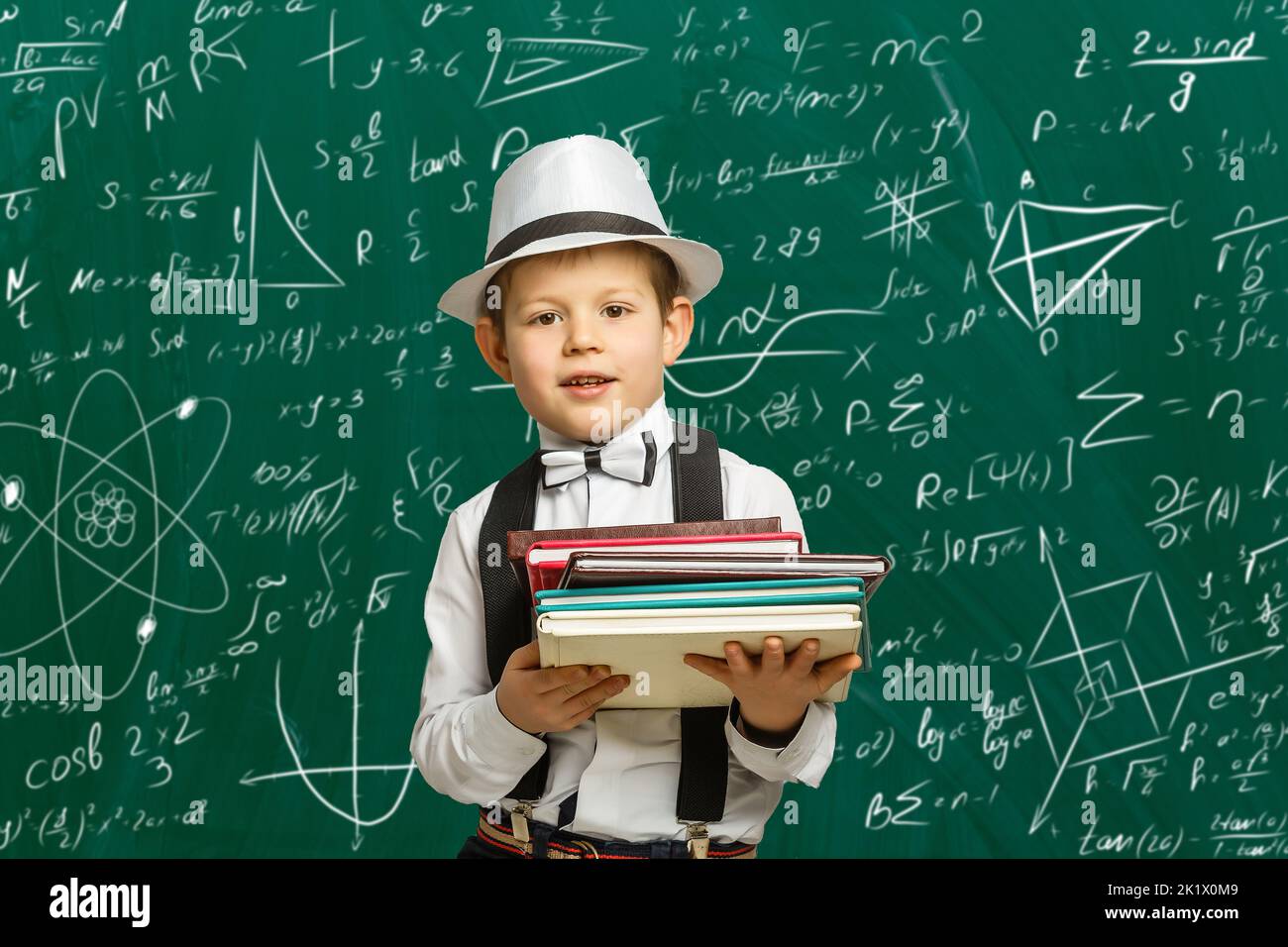 Portrait of a clever little boy in school uniform in the background of ...