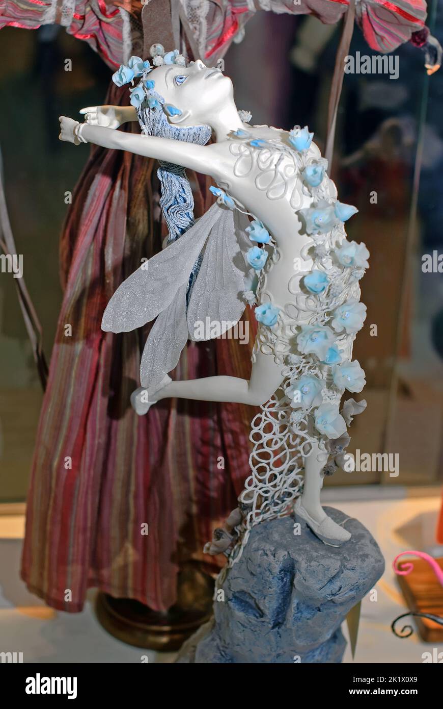 A collectible doll, a white fairy with blue flowers, is on display at ...