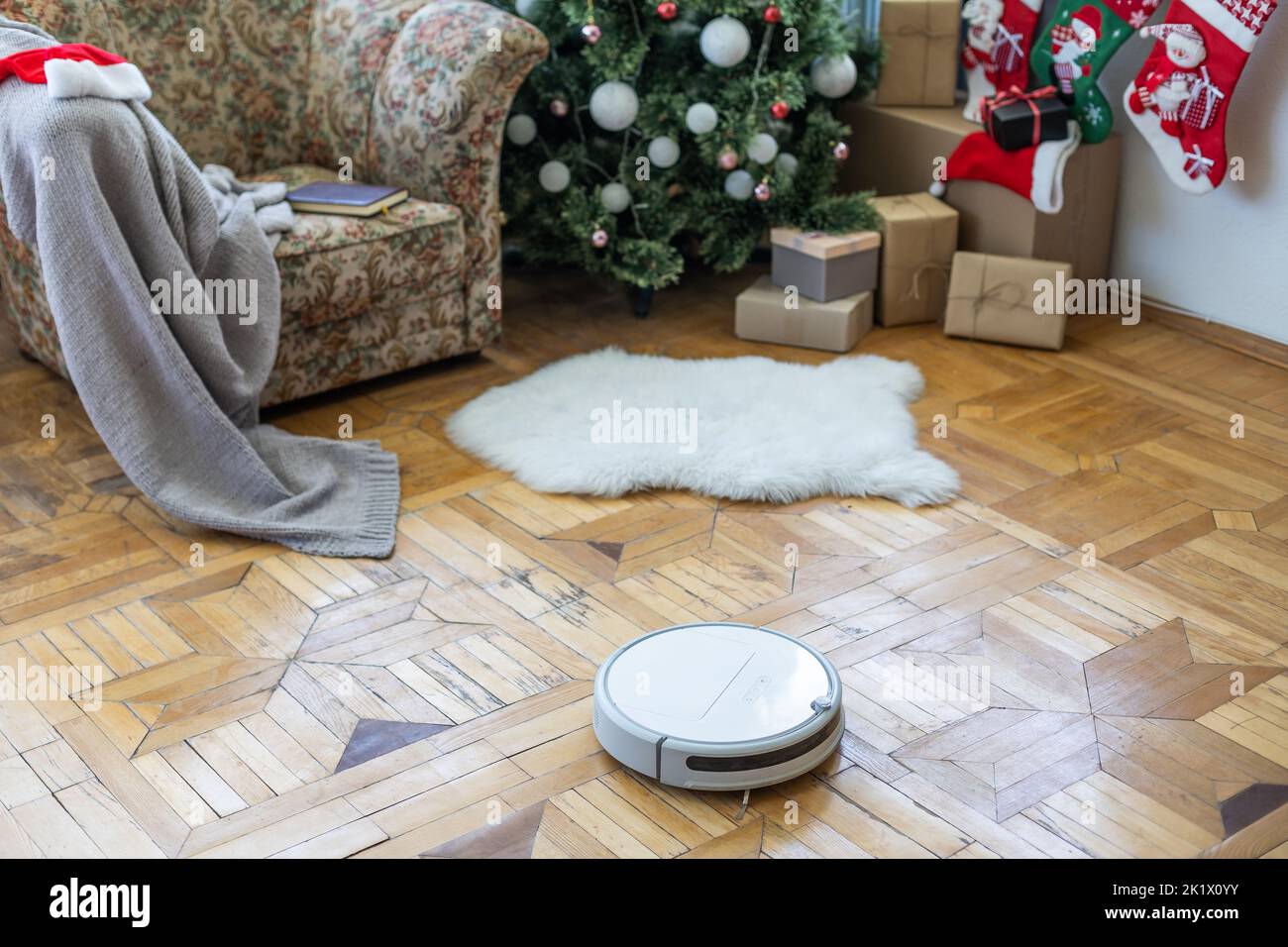 Smart home. Robot vacuum cleaner performs automatic cleaning of the ...