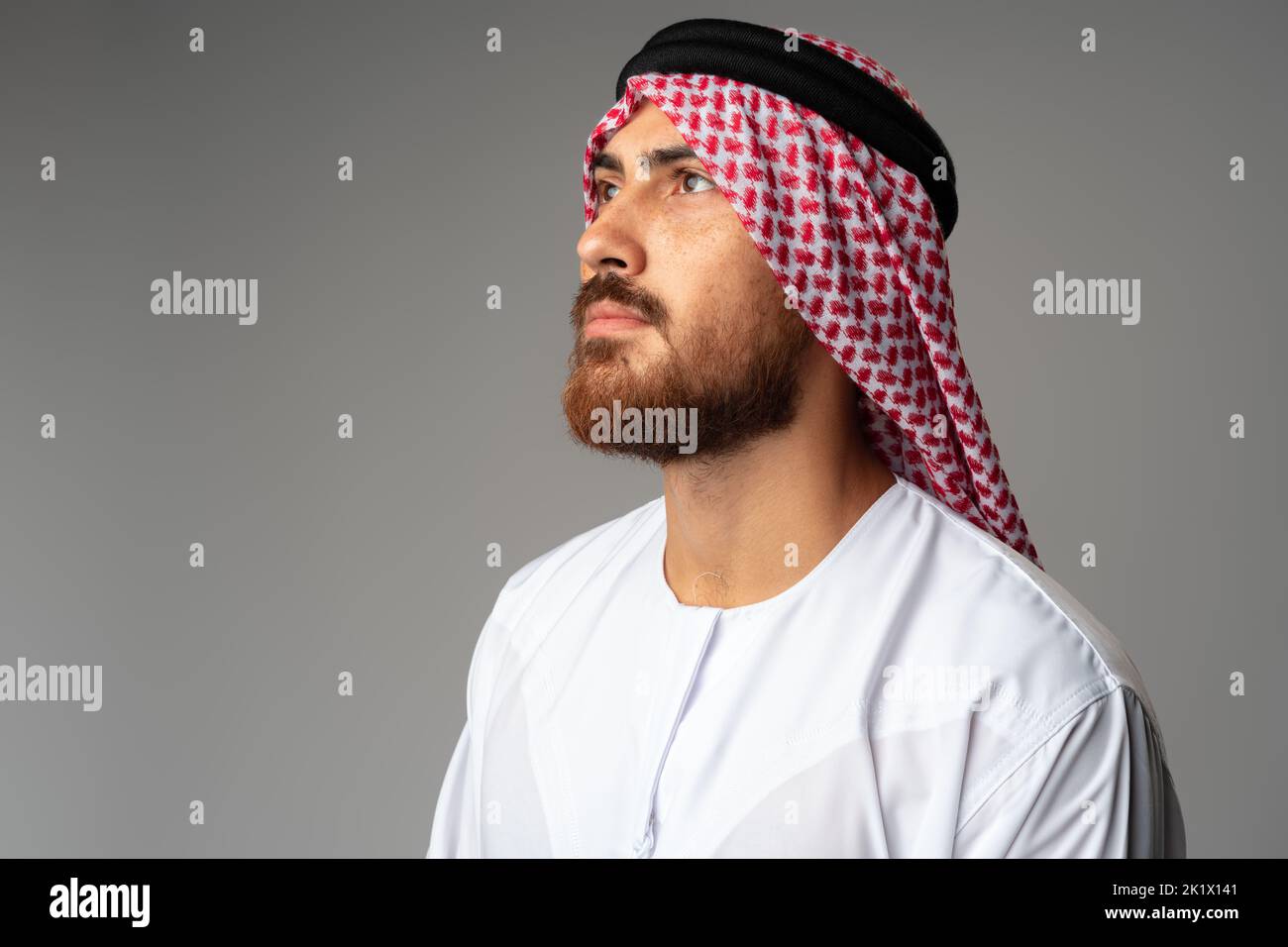 Portrait of young Arab man on gray background in studio Stock Photo - Alamy
