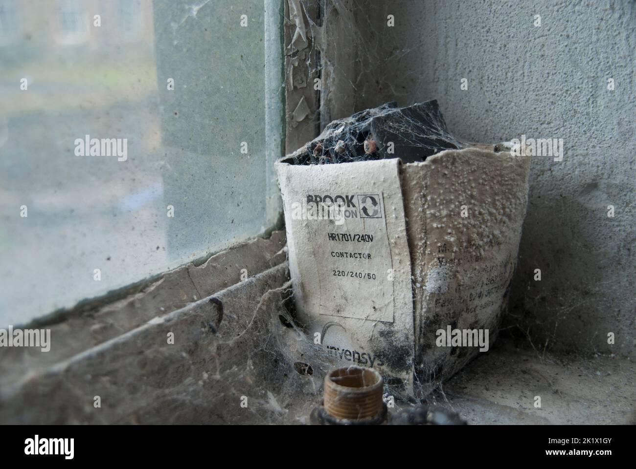 Equipment box sitting on the window sill of an abandoned building ...