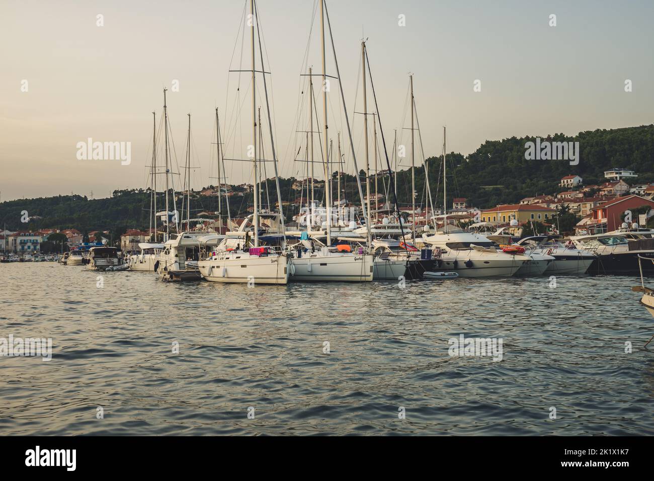 ships in the port of Rab at sunset in the Mediterranean sea on Croatian ...