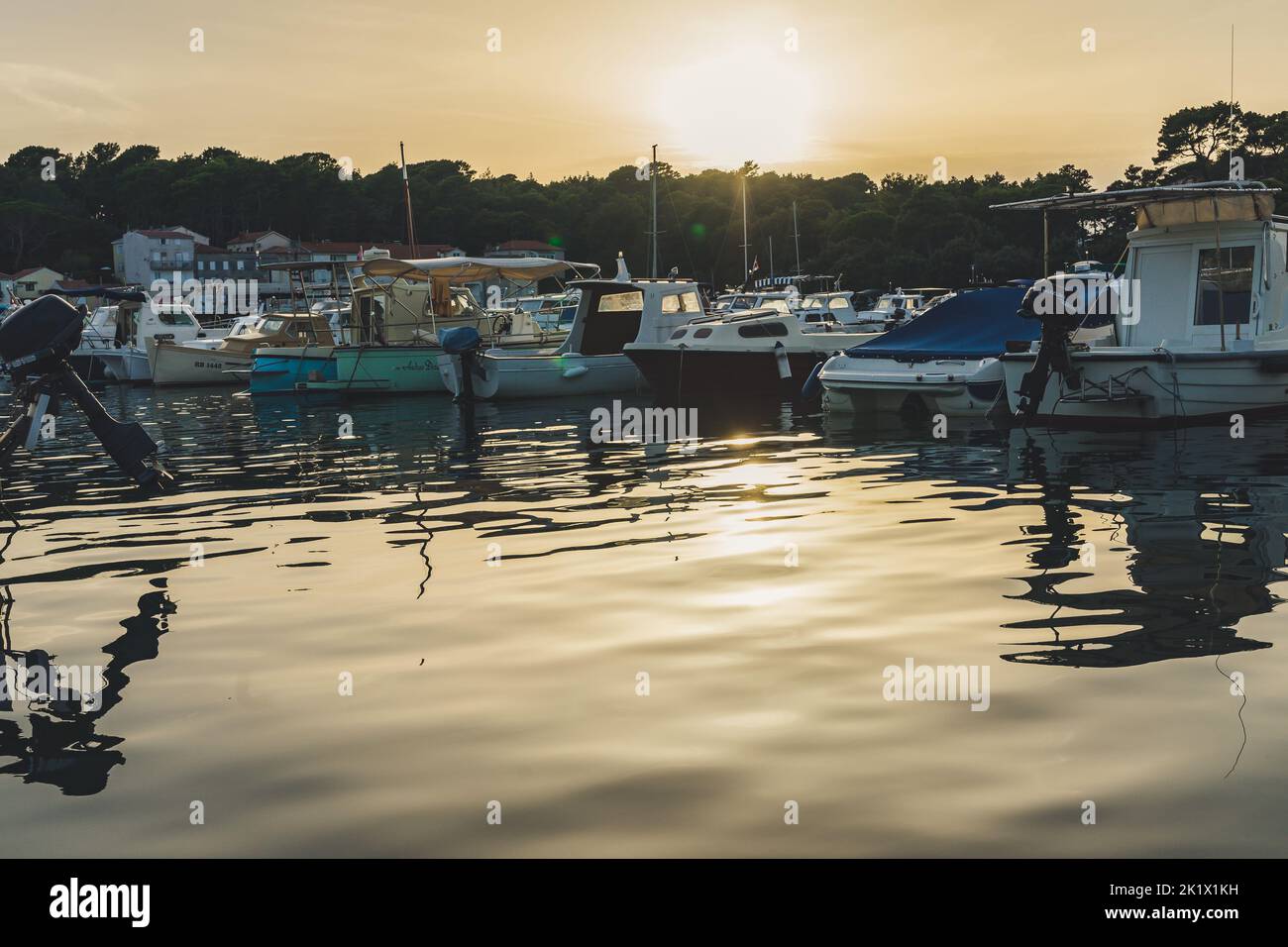 ships in the port of Rab at sunset in the Mediterranean sea on Croatian ...