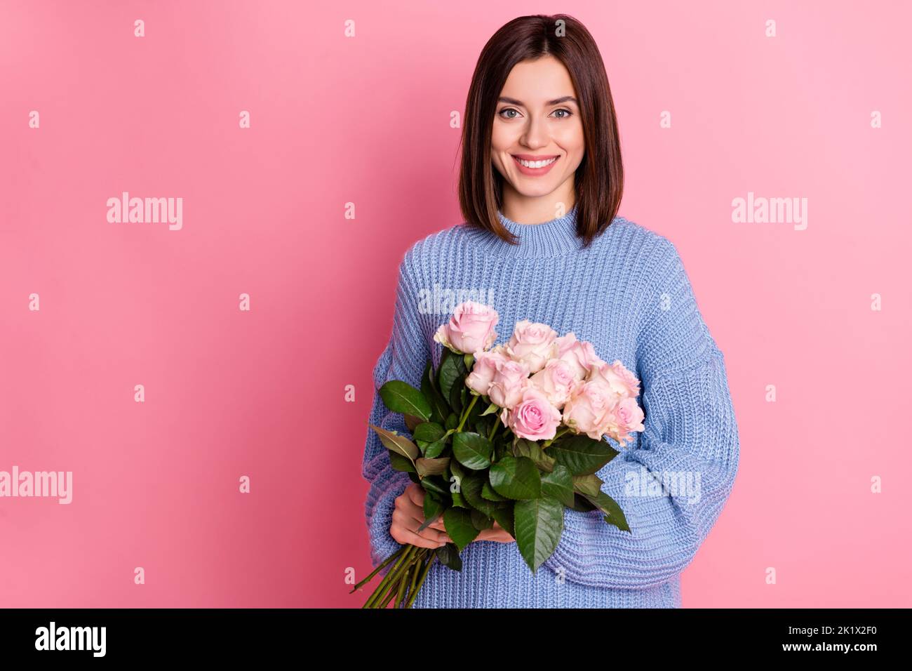 Portrait of young adorable cute smiling woman holding hand roses ...