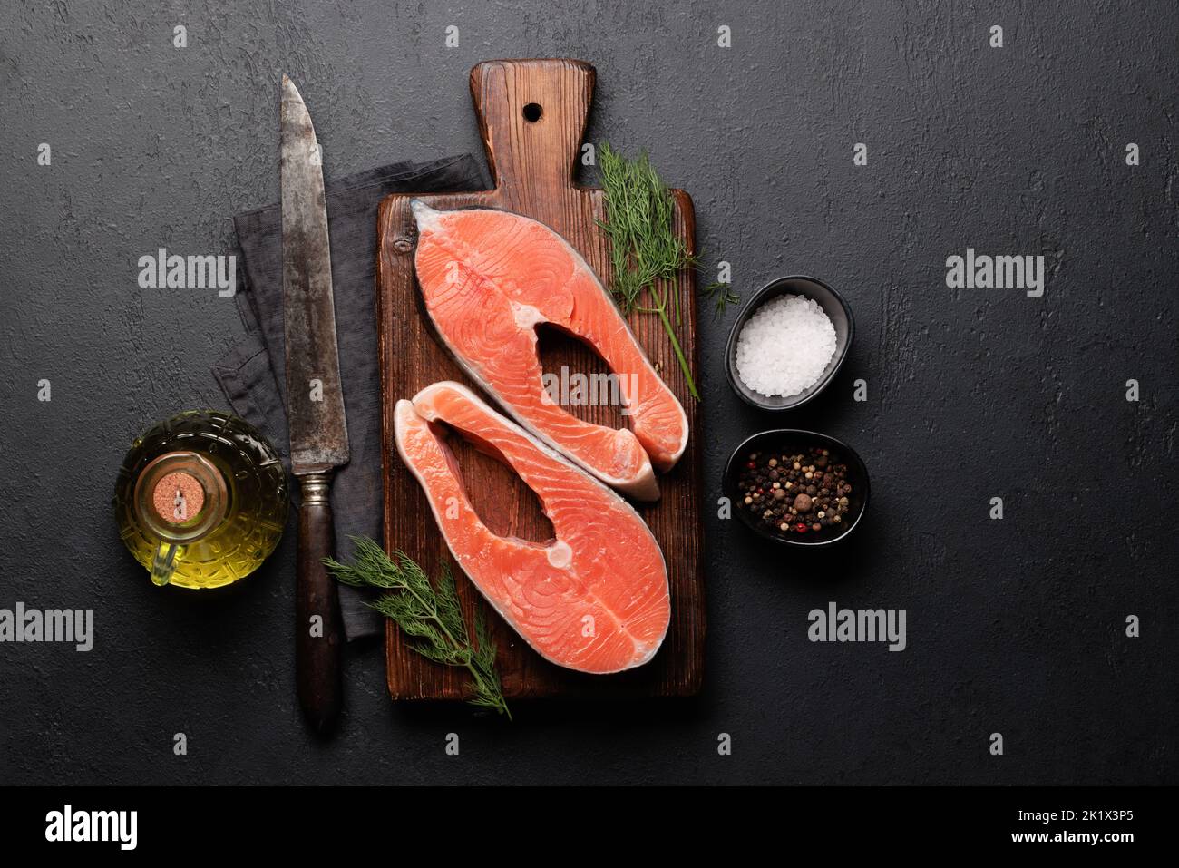 Fresh salmon steak. Two fish steaks and spices. Flat lay with copy ...