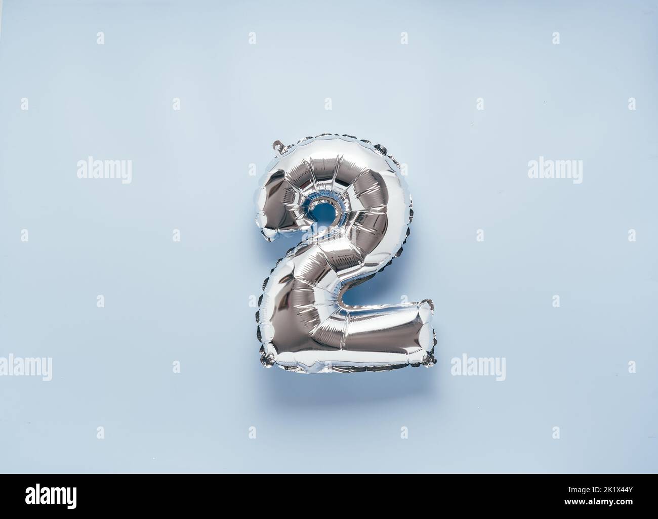 Silber balloon number 2 on light blue background for your New Year of ...