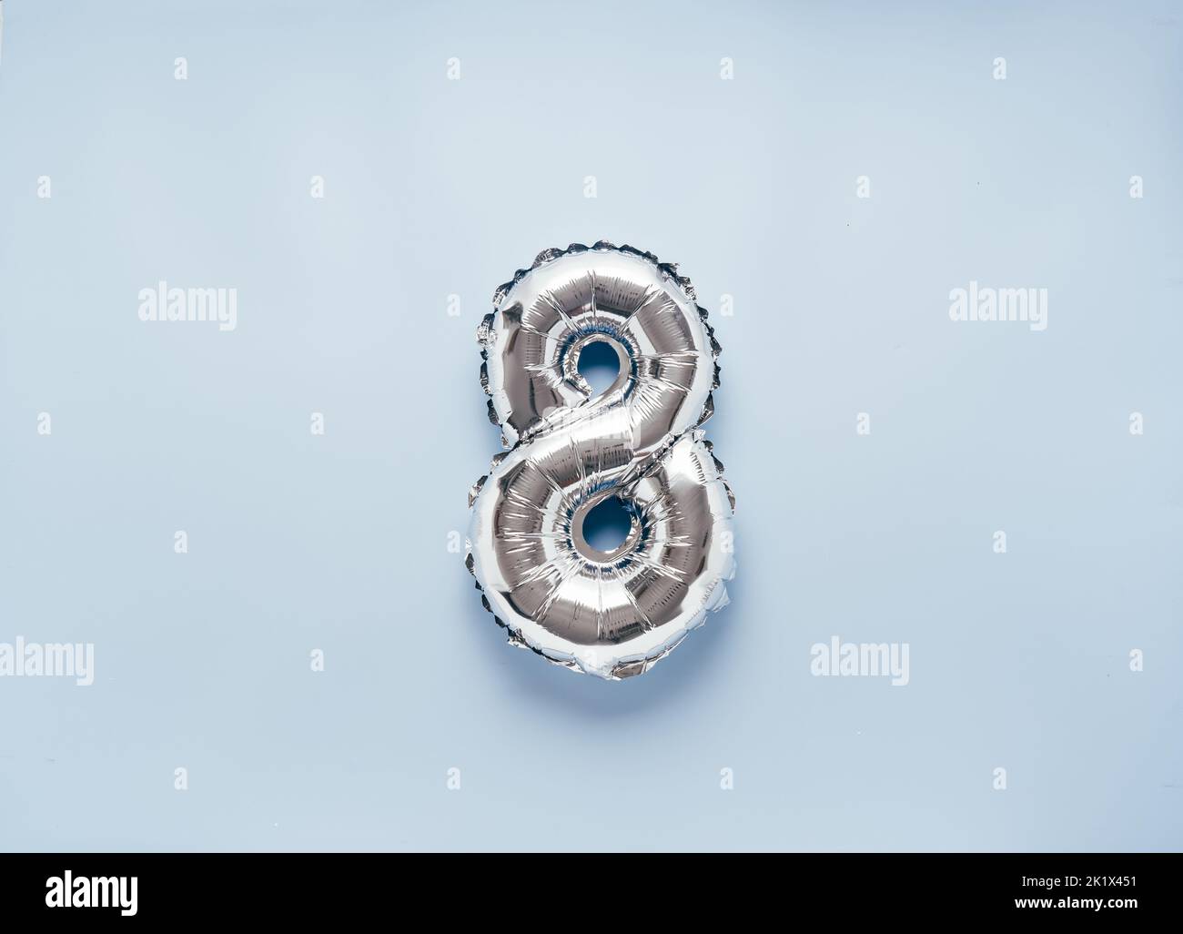Silber balloon number 8 on light blue background for your New Year of ...