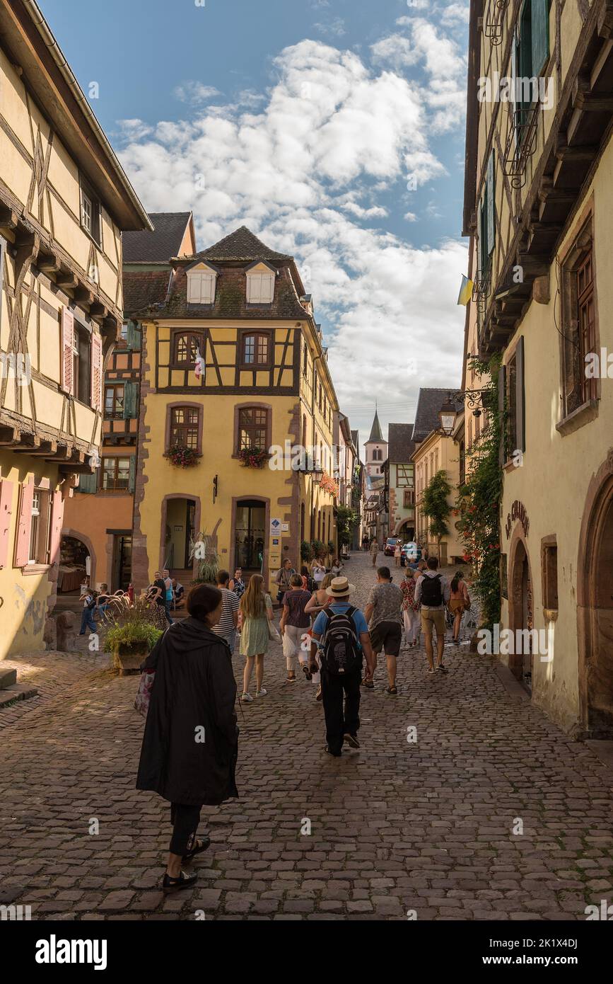 People on street in medieval village of Riquewihr, Alsace, France Stock ...