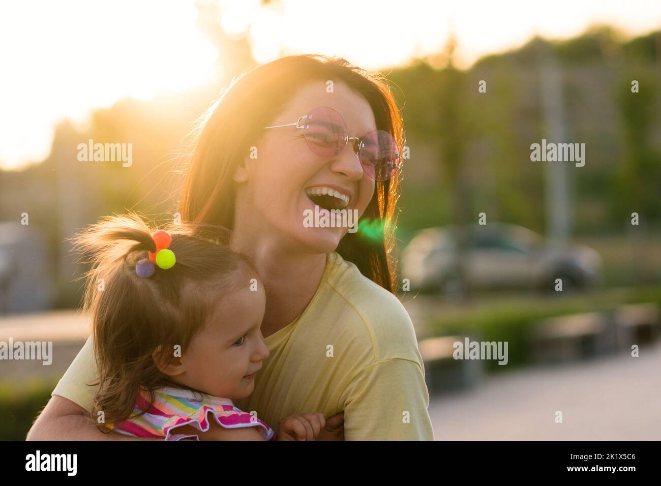Mom and little daughter having fun and spend time together, hugging at ...