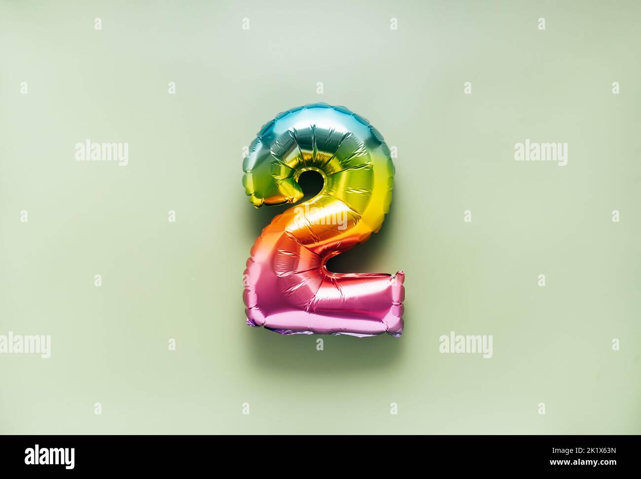 Colorful balloon number 2 on light green background. New Year of ...